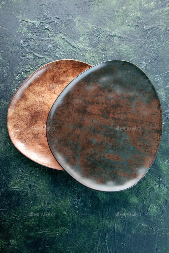 top view unusual shaped plates on dark background color dinner cutlery ...