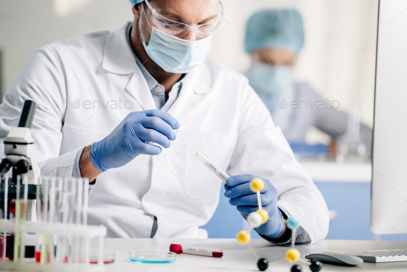 selective focus of genetic consultant doing dna test in lab Stock Photo ...