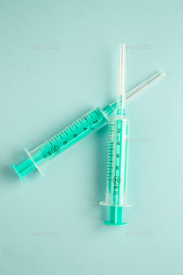 top view green injections on blue background virus health hospital ...