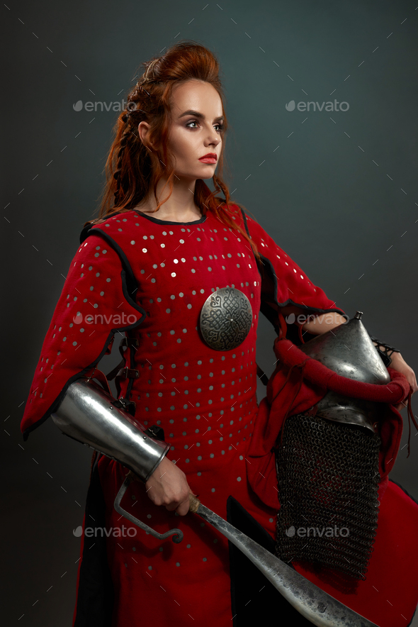 Courageous warrior keeping helmet and knife and posing Stock Photo by ...