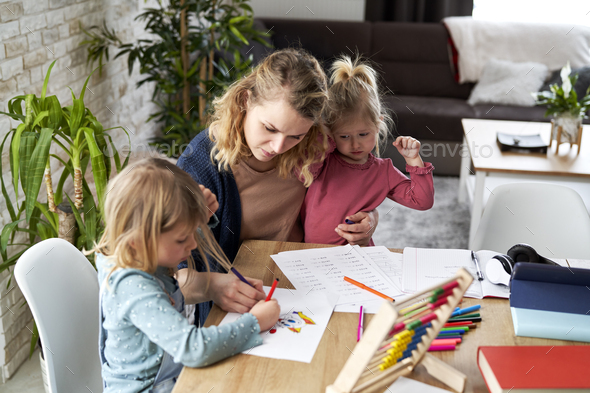 Mother looking after children at home during the lockdown Stock Photo ...