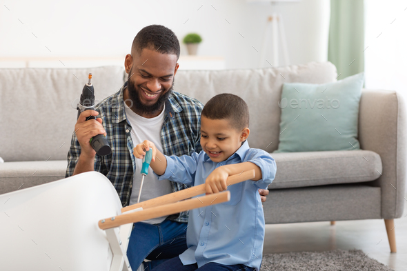 Black Father And Son Fixing Table Doing Housework Together Indoor Stock ...