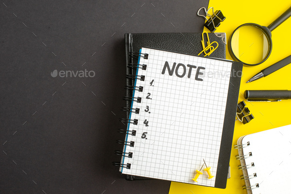 top view open notepad with note and numbers inside on dark-yellow ...
