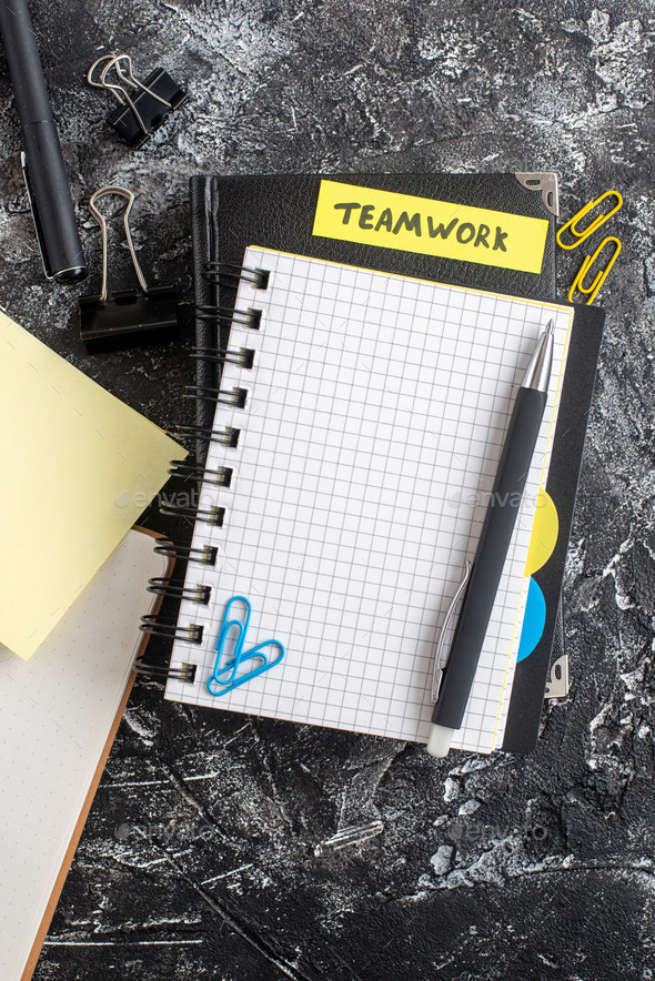 top view teamwork note attached to black notepad on dark background ...
