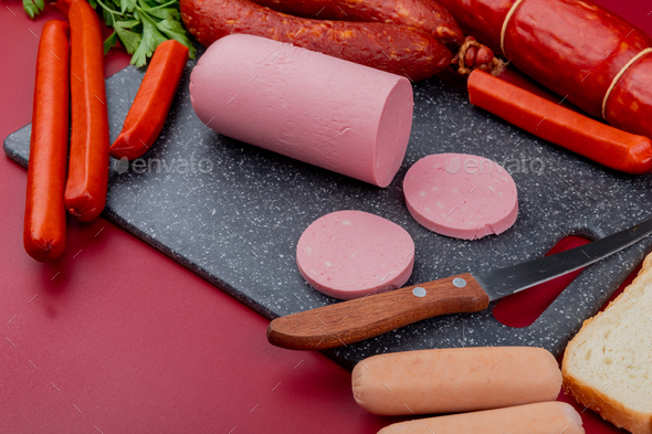 side view of sausages as cut boiled one and hunting ones with smoked ...