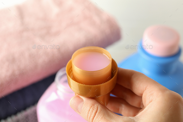 Female hand hold cap with detergent, close up Stock Photo by AtlasComposer