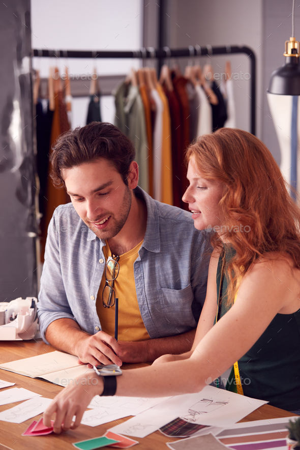 Male And Female Students Or Business Owners Working On Designs In ...