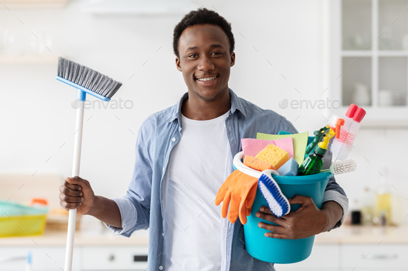 Excited black guy ready for cleaning apartment Stock Photo by Prostock ...