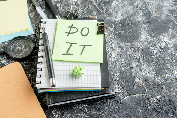 front view do it note with stickers pen and notepad on dark background ...