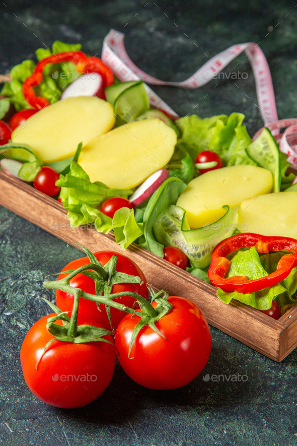 Vertical view of chopped vegetables fresh tomatoes with stem meter on a ...