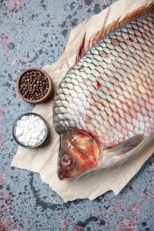 top view fresh raw fish with pepper on blue background food meal ocean ...