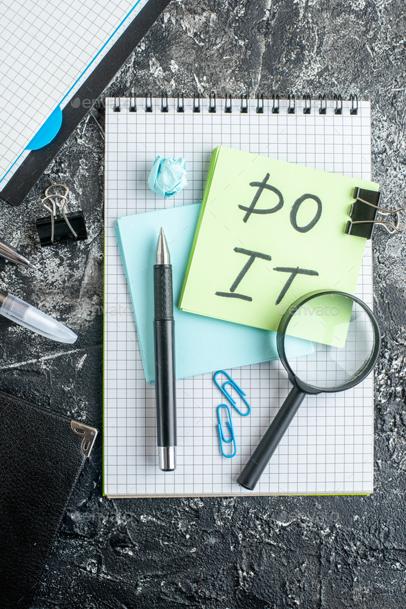 top view do it note with stickers and notepad on dark background ...