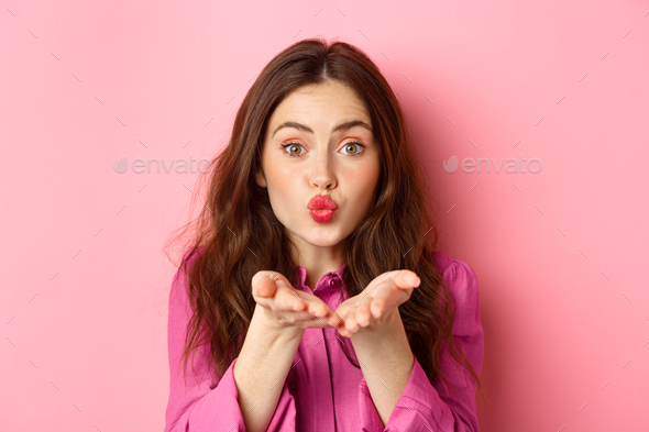 Close up portrait of cute romantic girl pucker her lips, sending air ...