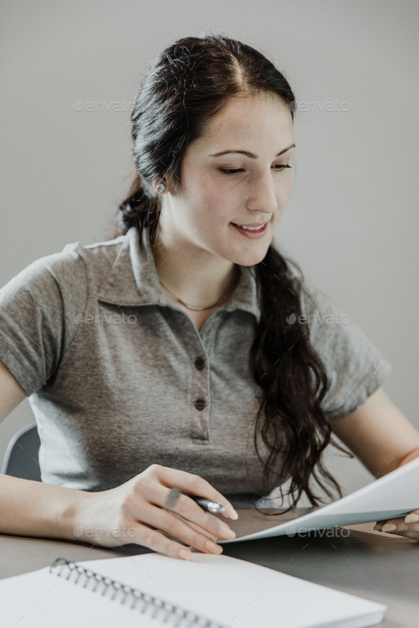 Student reading a note in class Stock Photo by Rawpixel | PhotoDune