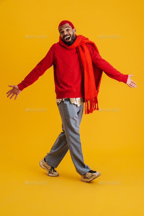 Delighted african american guy walking with throwing up arms Stock ...