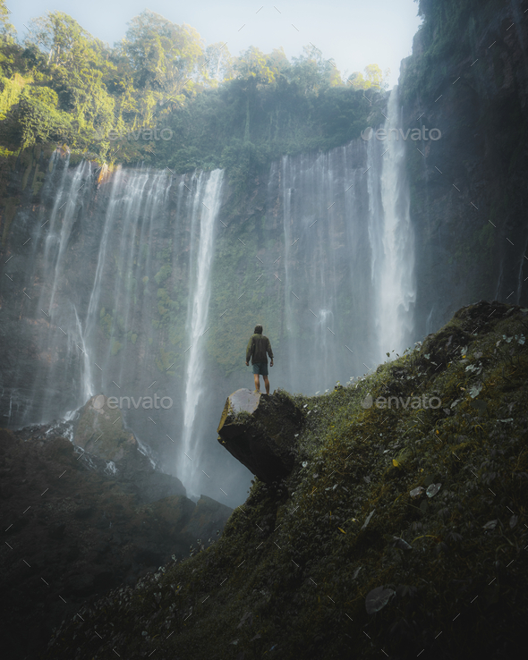 Man standing by Tumpak Sewu Waterfalls Stock Photo by Rawpixel | PhotoDune