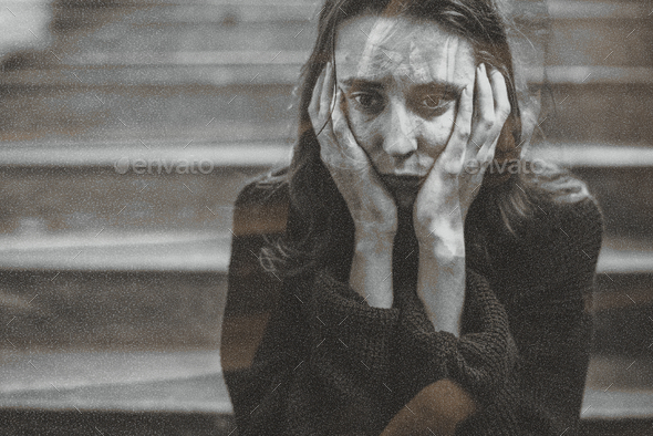 Distressed woman sitting on a staircase thinking deeply Stock Photo by ...