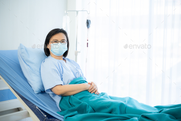 Female patients wear a surgical face mask while being in hospital ...