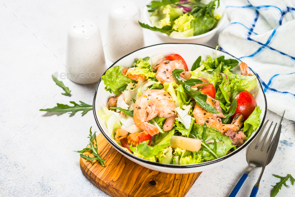 Seafood salad with green leaves and vegetables. Stock Photo by Nadianb