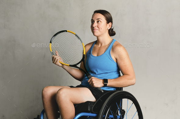 Female athlete in a wheelchair holding a tennis racket Stock Photo by ...