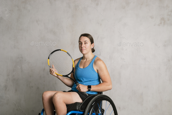 Female athlete in a wheelchair holding a tennis racket Stock Photo by ...