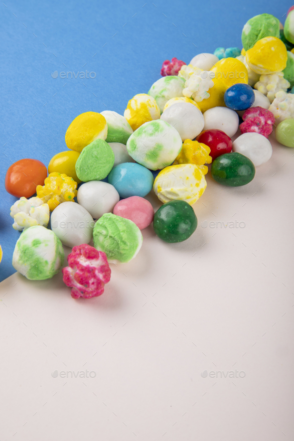 side view of candies in multi-colored glaze on blue and white ...
