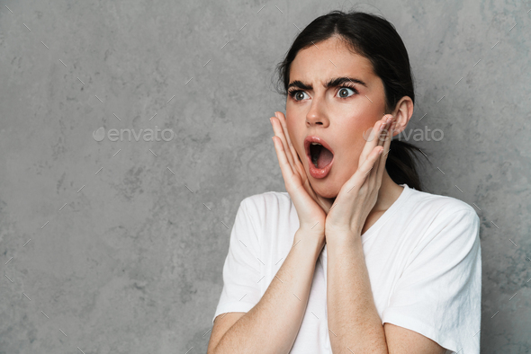 Shocked beautiful young woman screaming Stock Photo by vadymvdrobot