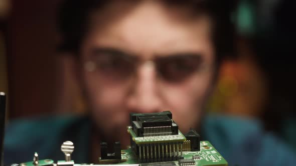Concentrated Hacker Looking at Microchip Closeup, Stock Footage | VideoHive