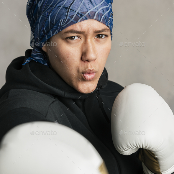 Young Islamic woman wearing a sport hijab while boxing Stock Photo by ...