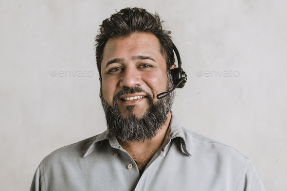 Indian operator assistant using a microphone headset while conversing ...