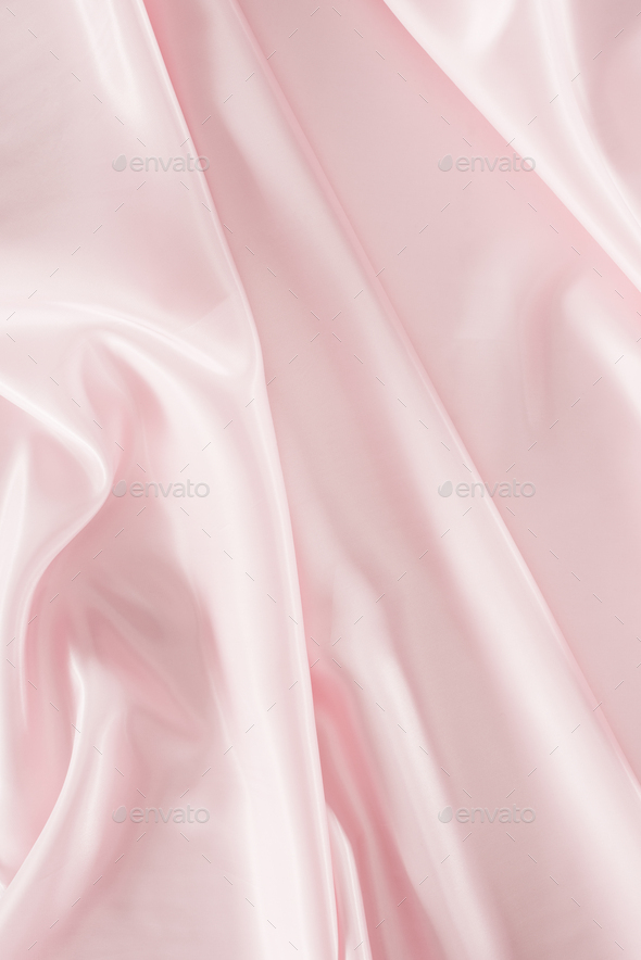 light pink shiny satin fabric background Stock Photo by LightFieldStudios