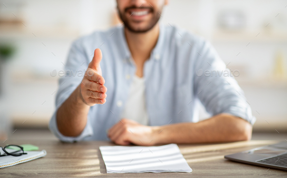 Handshake gesture. Unrecognizable positive bearded nan stretching hand ...