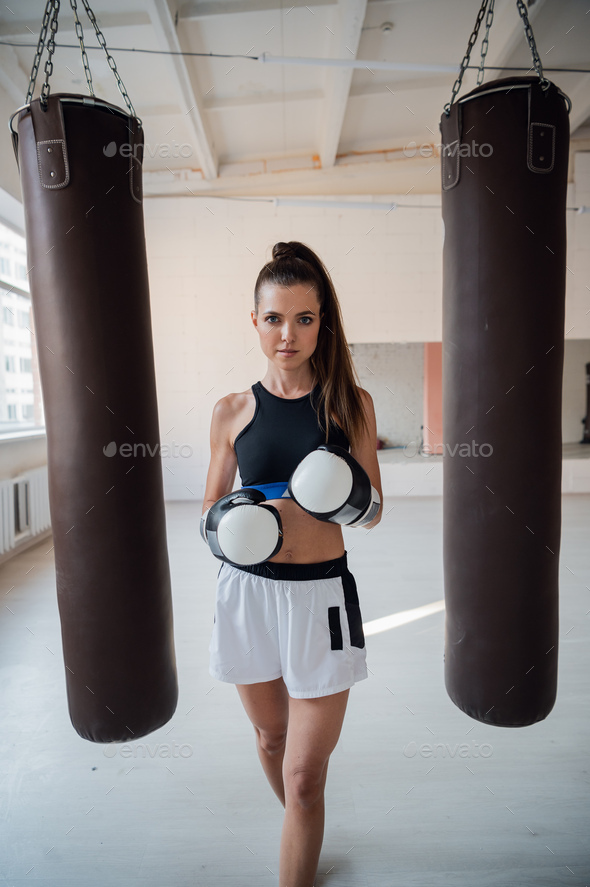 Cute girl posing for a photo in boxing gloves on the background of ...
