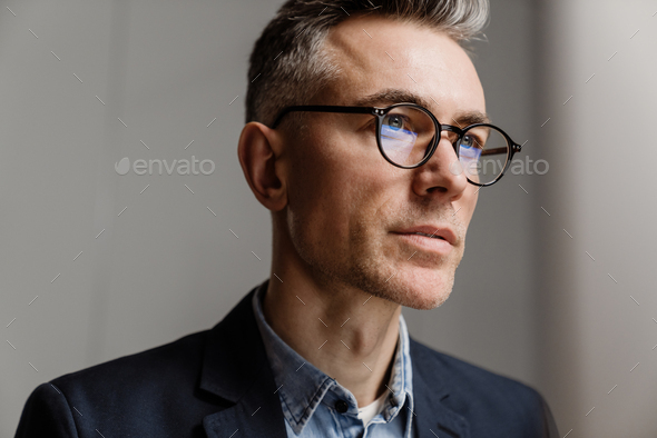 Serious grey man wearing eyeglasses thinking and looking forward Stock ...