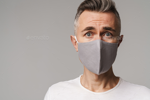 Portrait of scared man in medical mask Stock Photo by vadymvdrobot