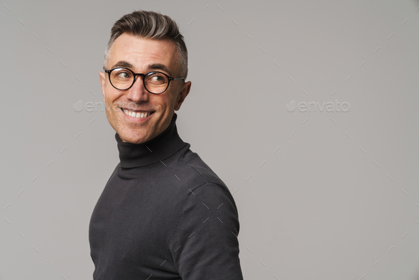Handsome confident smart looking man posing Stock Photo by vadymvdrobot