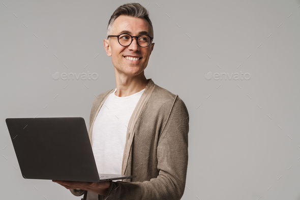 Confident handsome smart looking man standing Stock Photo by vadymvdrobot
