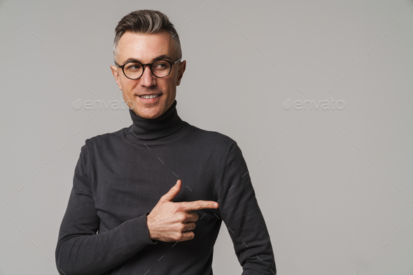 Handsome confident smart looking man posing Stock Photo by vadymvdrobot