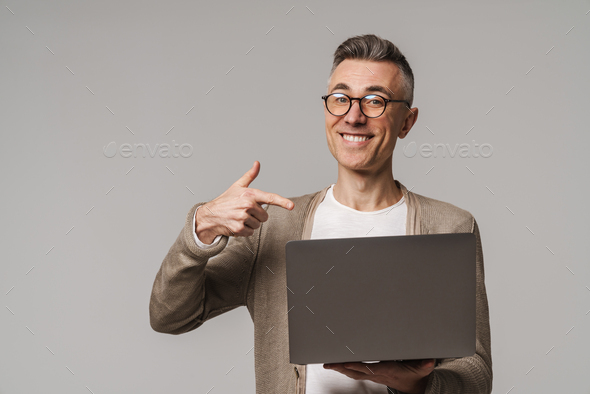 Confident handsome smart looking man standing Stock Photo by vadymvdrobot