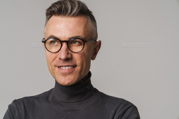 Handsome confident smart looking man posing Stock Photo by vadymvdrobot