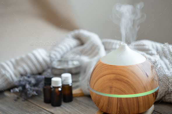Composition with an air humidifier and a set of aromatic oils close up ...