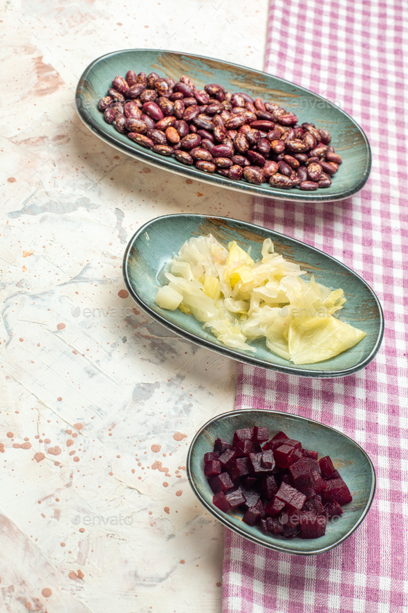 bottom view beans pickled cabbage cut beet on cyan oval plates purple ...