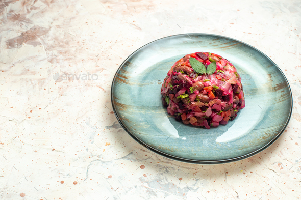 bottom view vinaigrette salad on cyan oval plate on light grey ...