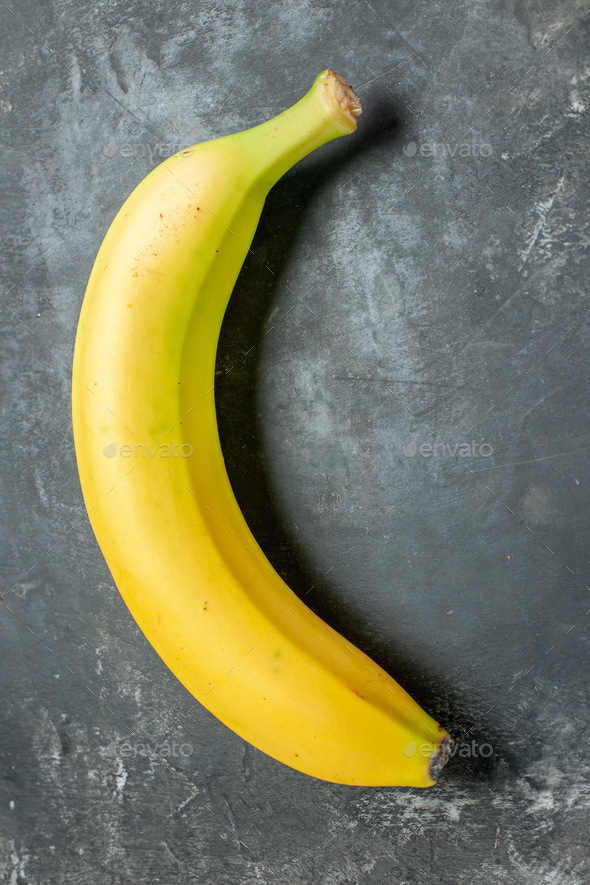 Vertical view of an organic nutrition source fresh banana on dark ...