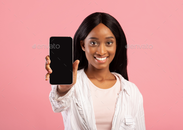 Positive black woman showing cellphone with space for mobile app design ...