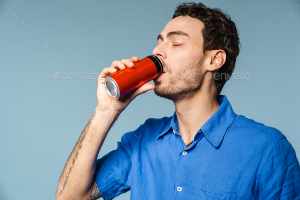 Happy handsome guy drinking soda with eyes closed Stock Photo by ...
