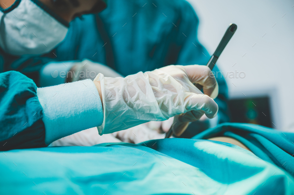 Medical team of surgeons in hospital doing invasive surgical ...