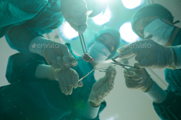 Medical team of surgeons in hospital doing invasive surgical ...