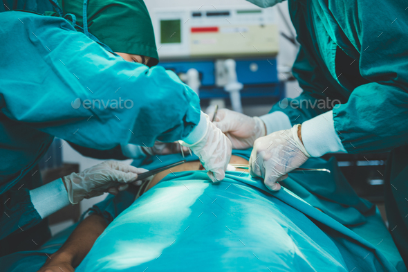 Medical team of surgeons in hospital doing invasive surgical ...