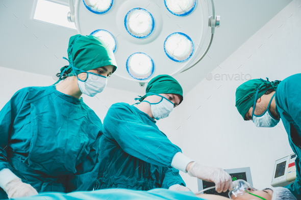 Medical team of surgeons in hospital doing invasive surgical ...